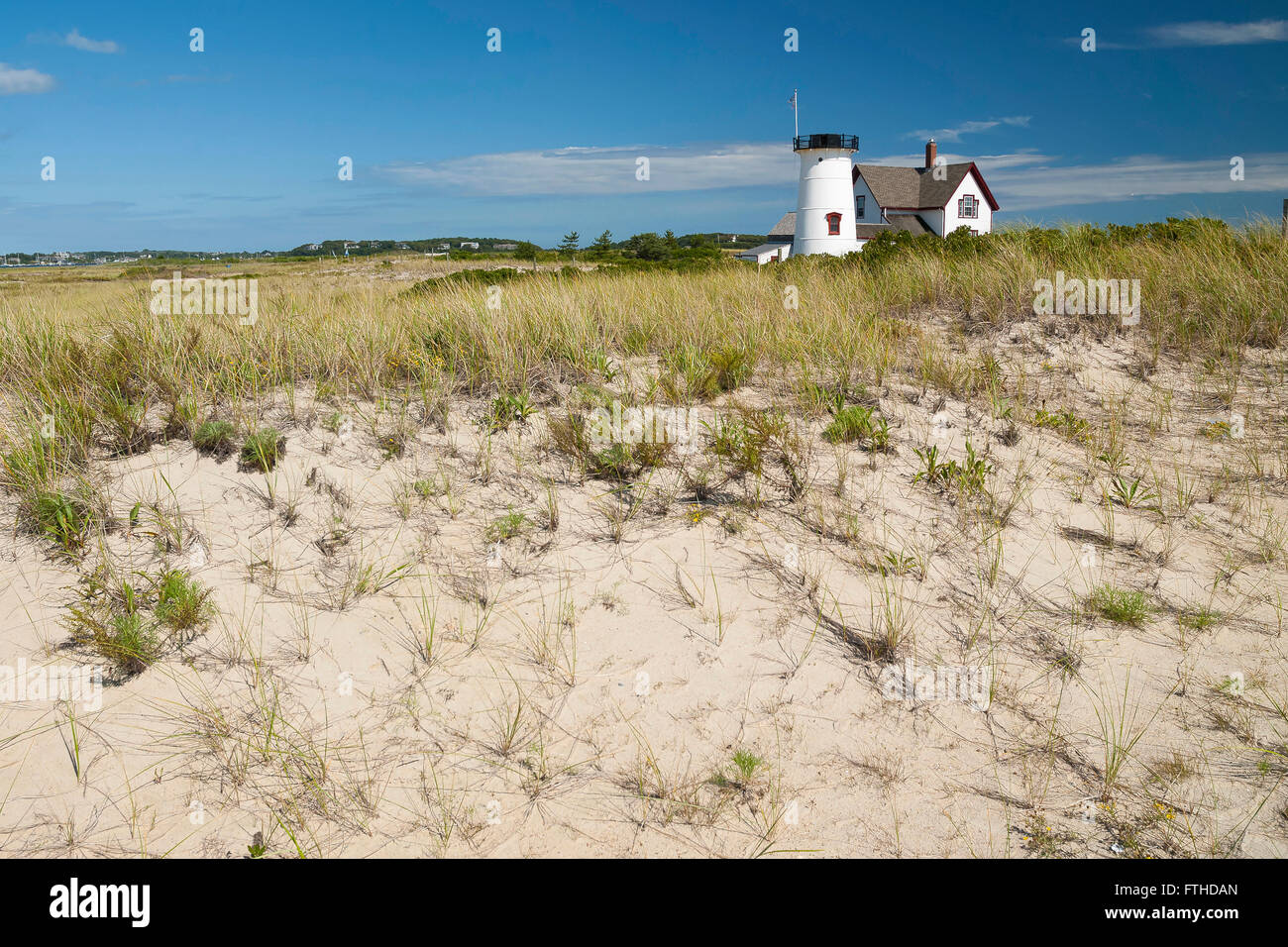 Stage Harbor lighthouse, without its lantern, on a Cape Cod beach, on a ...