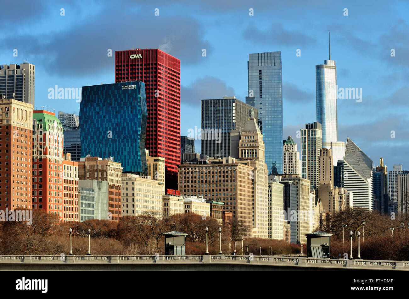 A portion of the Chicago skyline is illuminated beneath some low ...