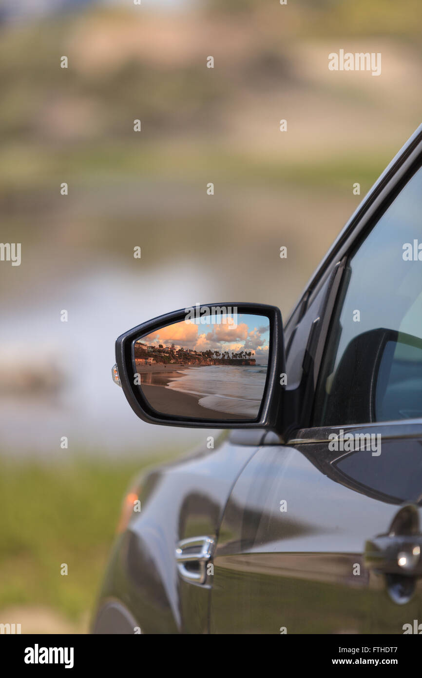 Sunset over Laguna Beach in the rear view window of a car in Southern ...