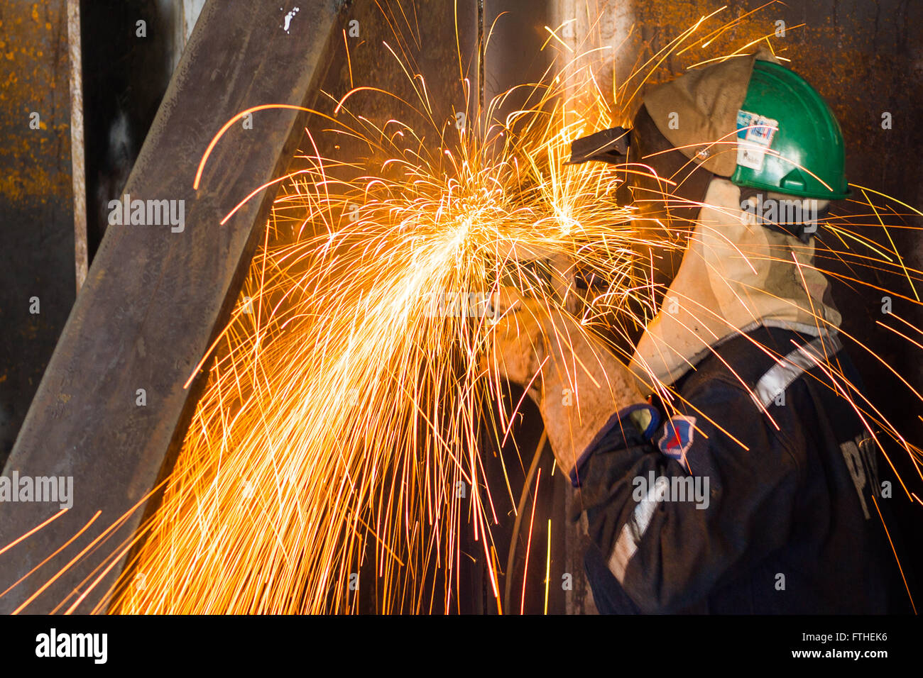 Man welding on oil rig Stock Photo - Alamy