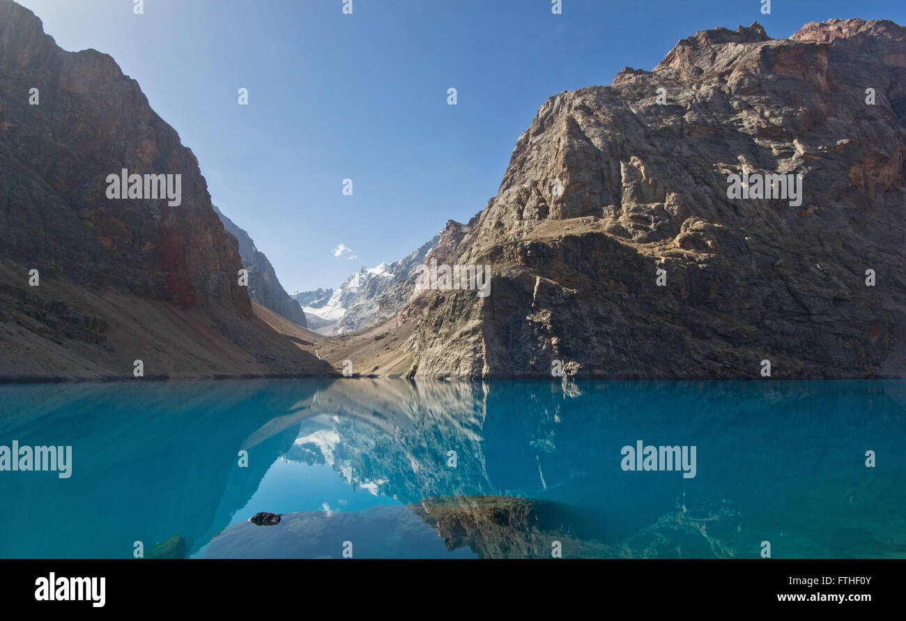 deep blue mountain lake at sunrise surrounded by high peaks Stock Photo ...