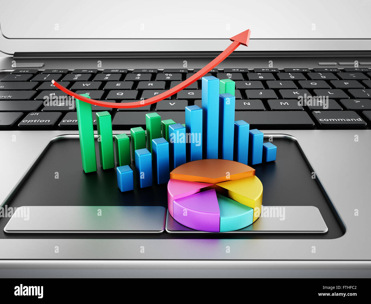 Financial charts standing on laptop computer keyboard Stock Photo - Alamy