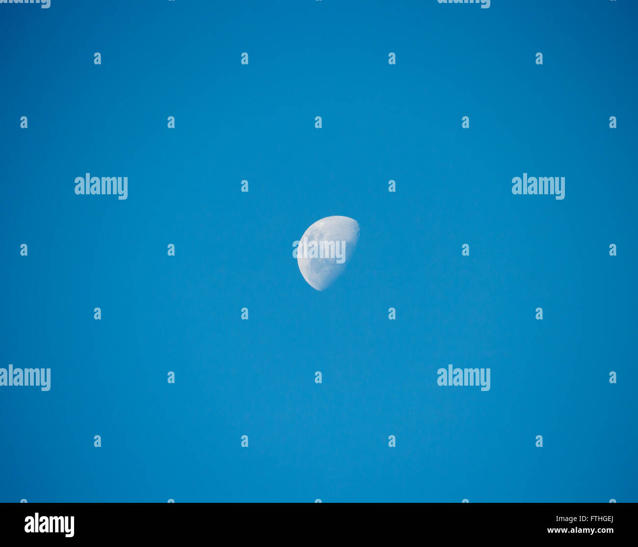 The moon in an early morning Australian sky reflects the sunlight ...