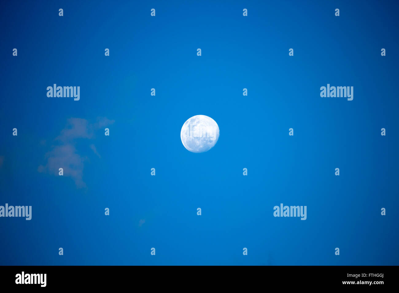 The moon in an early morning Australian sky reflects the sunlight ...