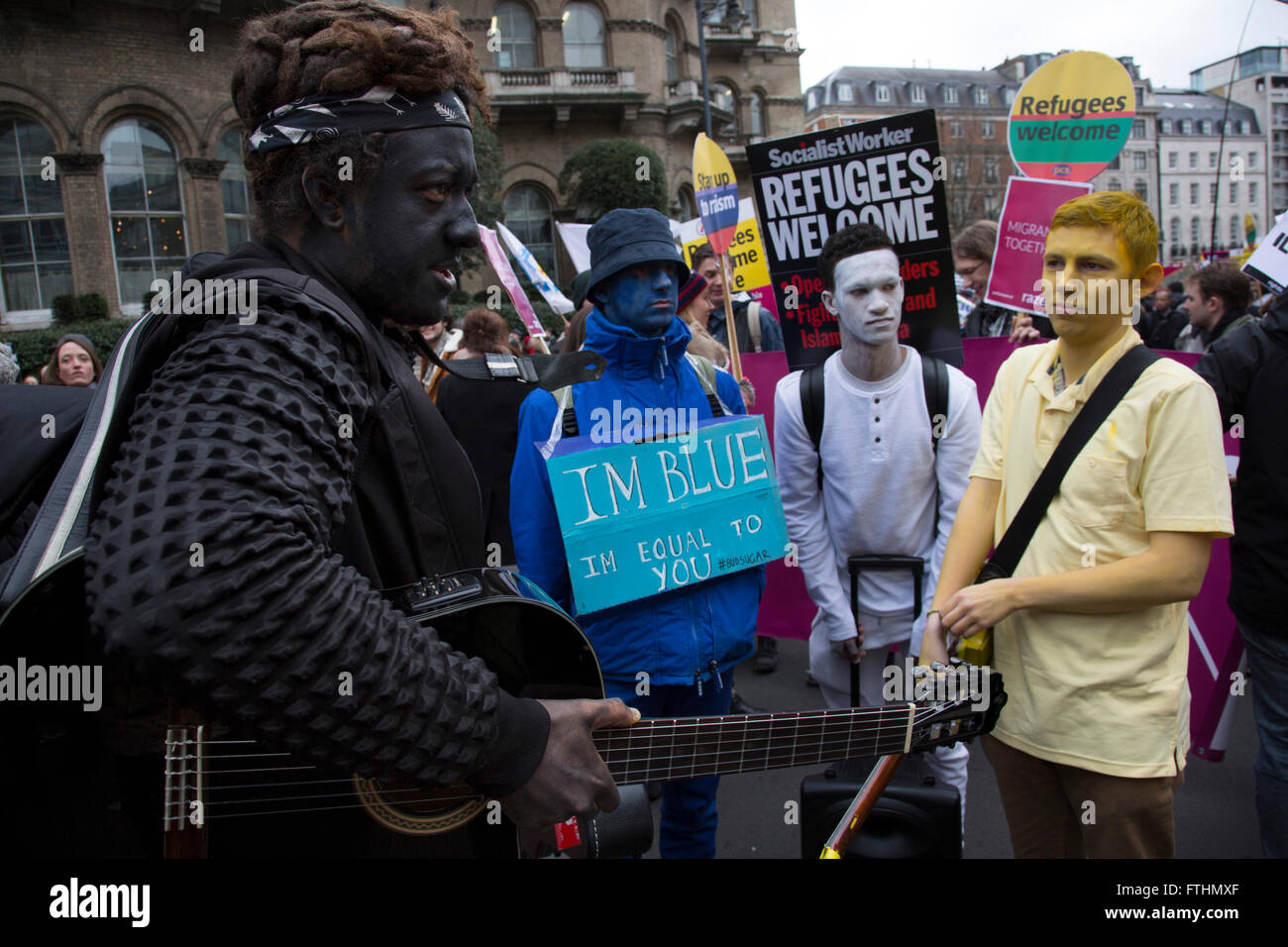 Demonstrators painted different colours and playing music at Anti ...
