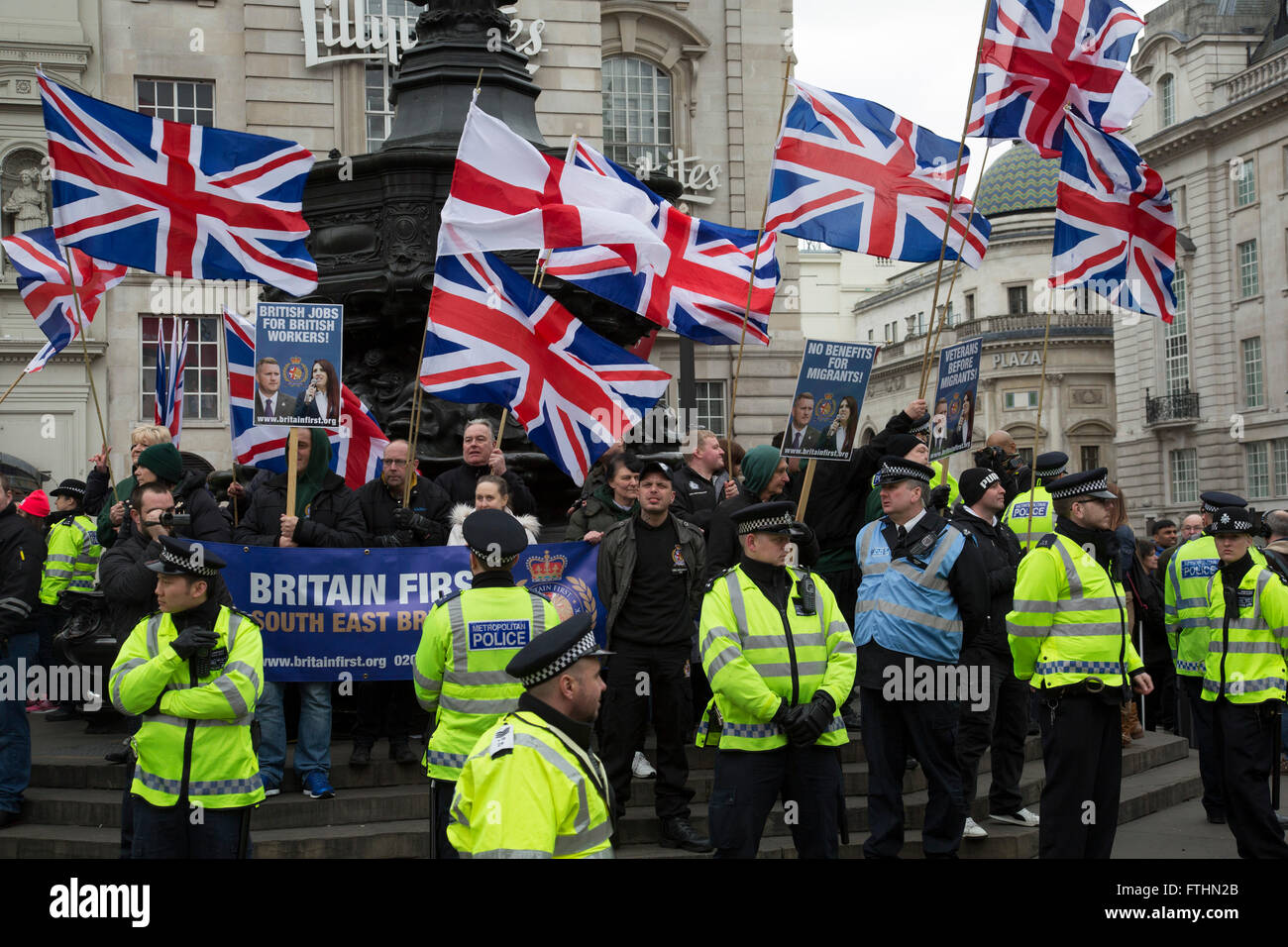 Members of Britain First in being protected by a ring of police during ...