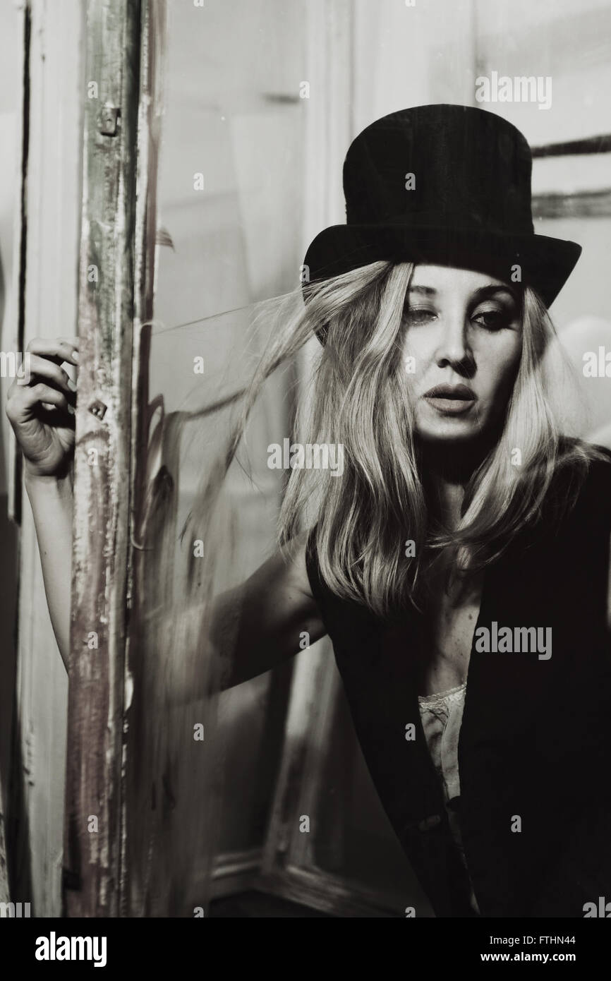 Portrait of a beautiful young woman dressed in black high hat Stock ...