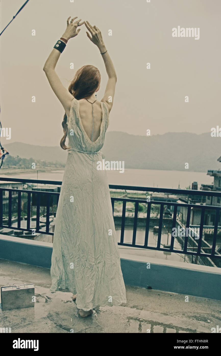 Young beautiful woman dancing on the roof Stock Photo - Alamy