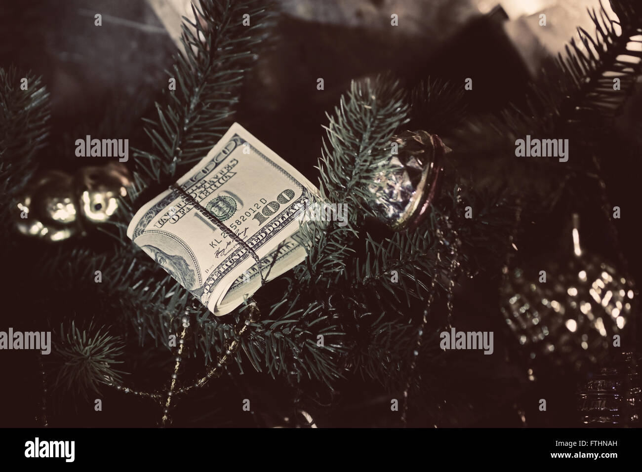 Stack of dollars under the Christmas fir Stock Photo - Alamy