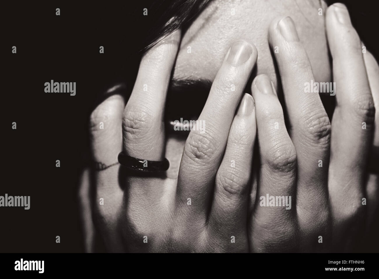 Portrait of a woman covers her face with hands Stock Photo - Alamy