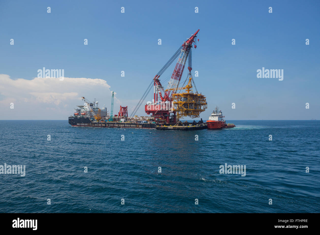 Oil rig lifting for installation on its jacket Stock Photo - Alamy