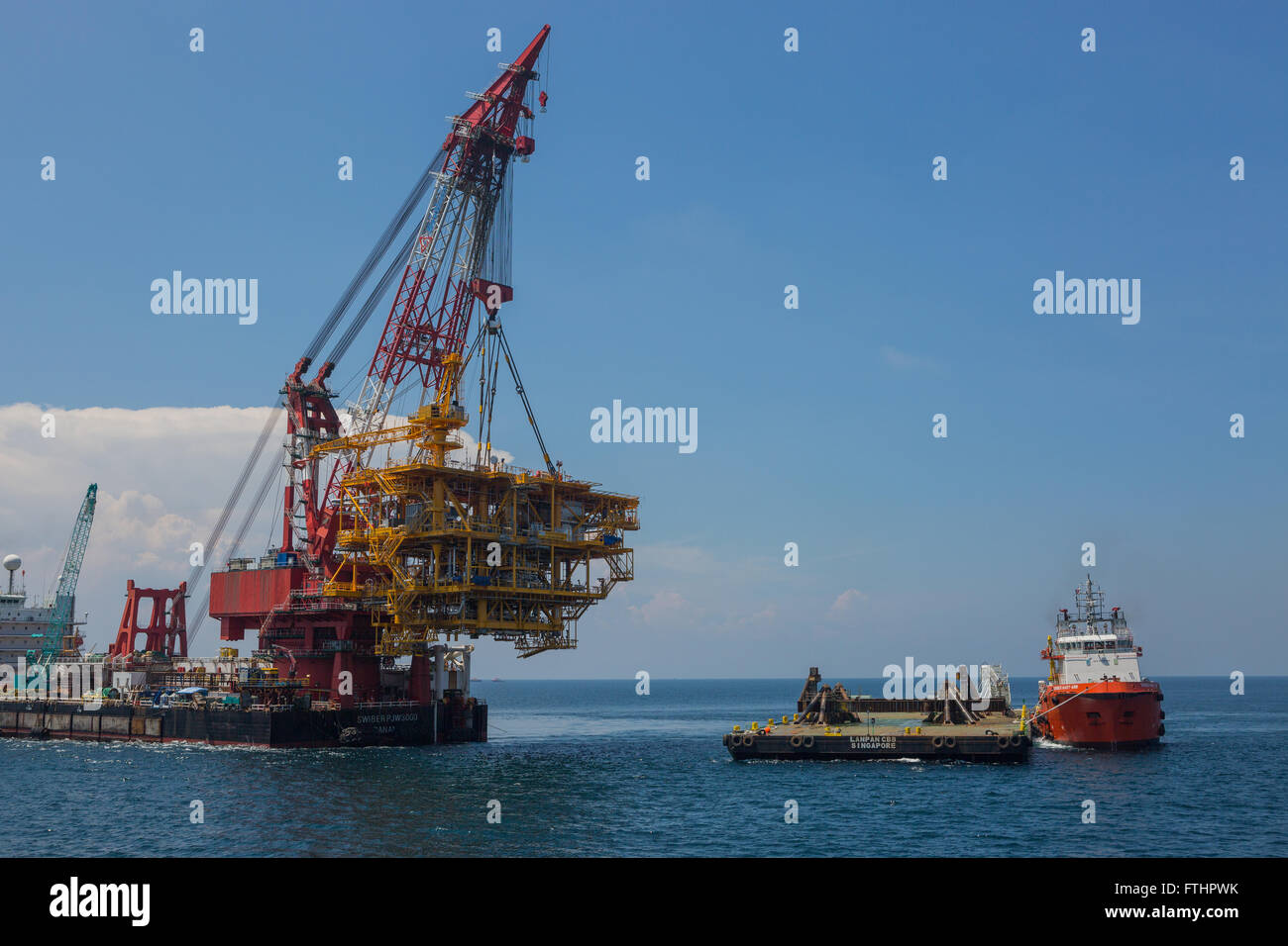 Oil rig lifting for installation on its jacket Stock Photo - Alamy