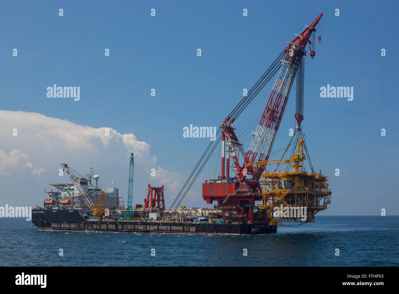 Oil rig lifting for installation on its jacket Stock Photo - Alamy
