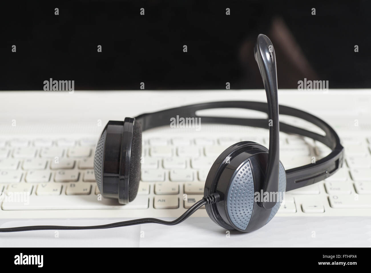 Headset with laptop computer keyboard.Communication concept Stock Photo ...