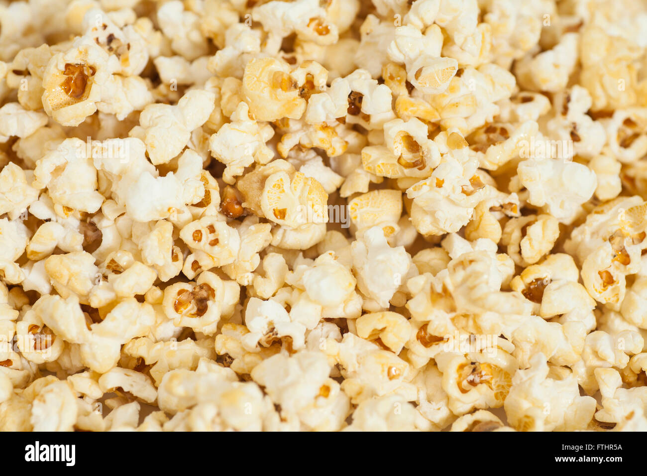 Salted popcorn grains texture background Stock Photo - Alamy