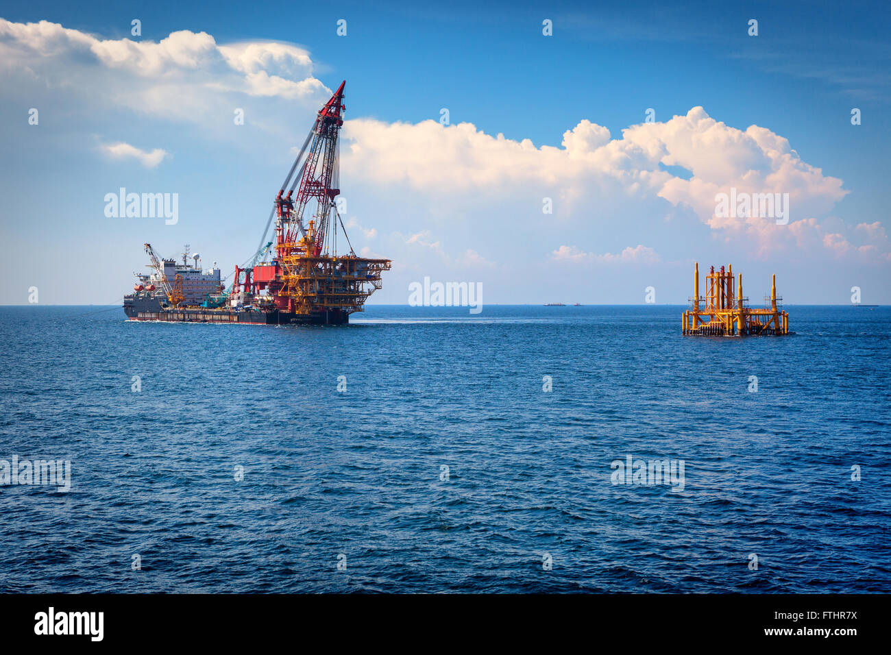 Oil rig lifting for installation on its jacket Stock Photo - Alamy