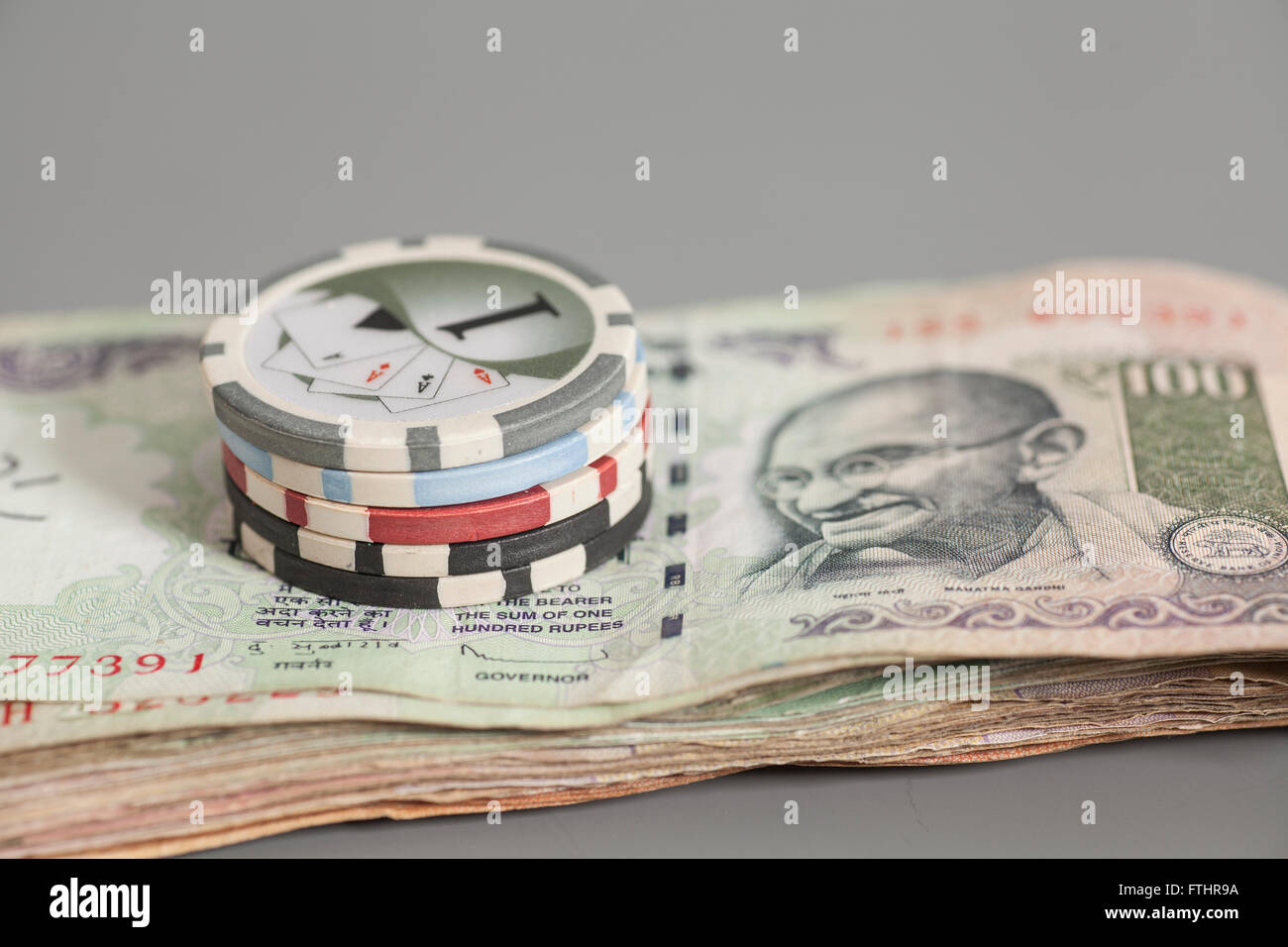 Poker chips on Indian Currency Rupee bank notes on gray background ...
