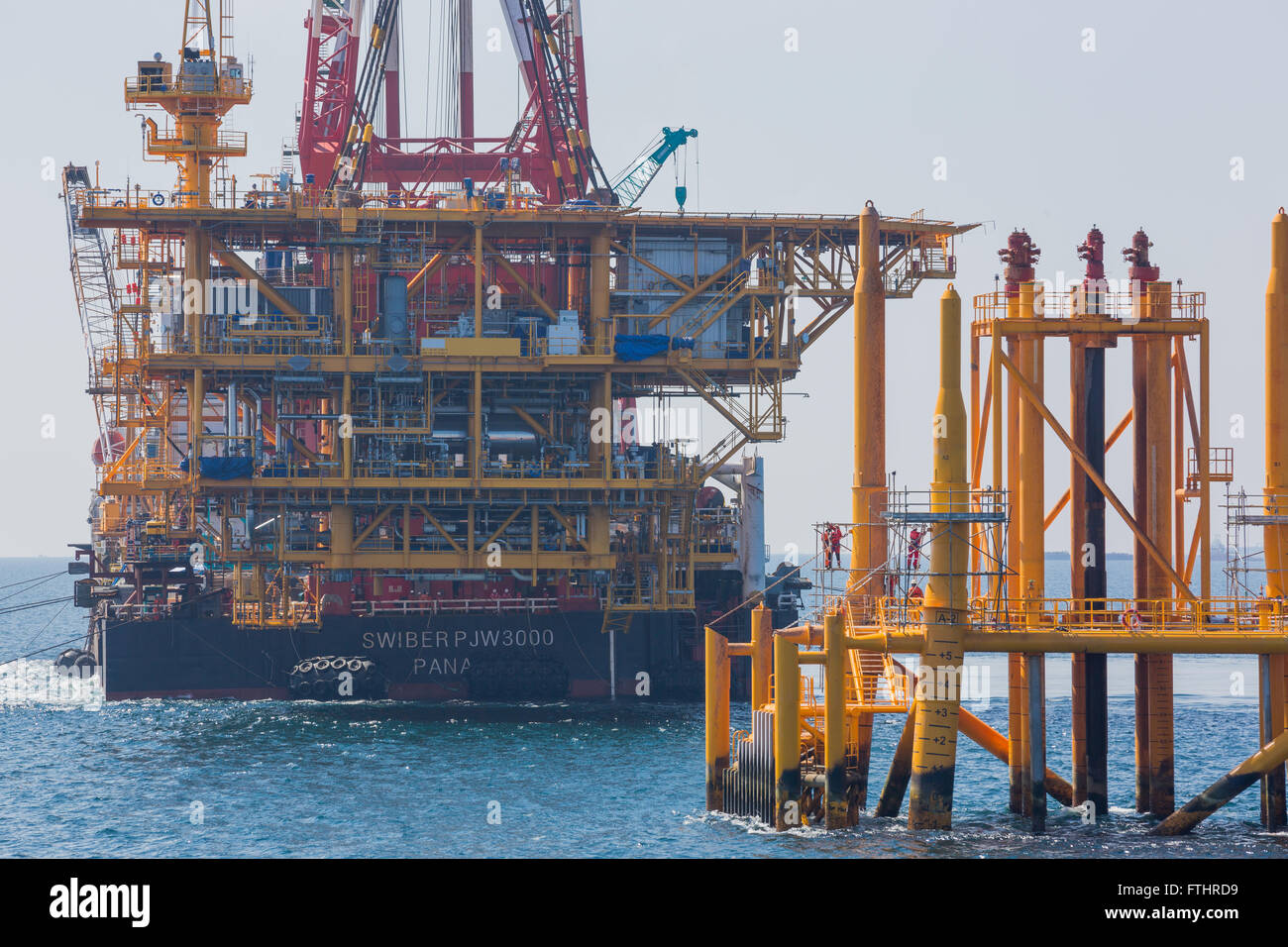Oil rig lifting for installation on its jacket Stock Photo - Alamy