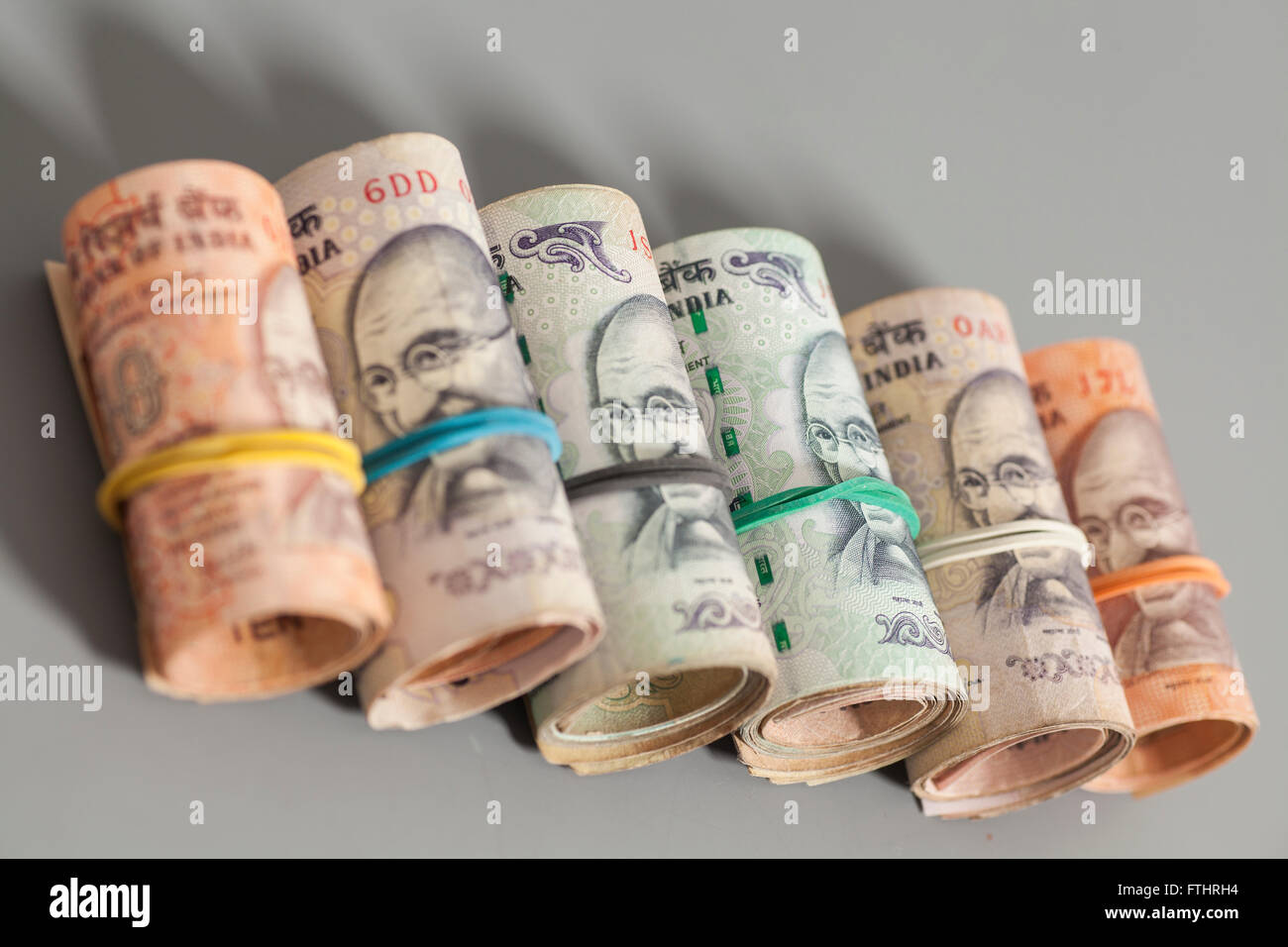 Roll of Indian rupee banknotes isolated on gray Stock Photo - Alamy