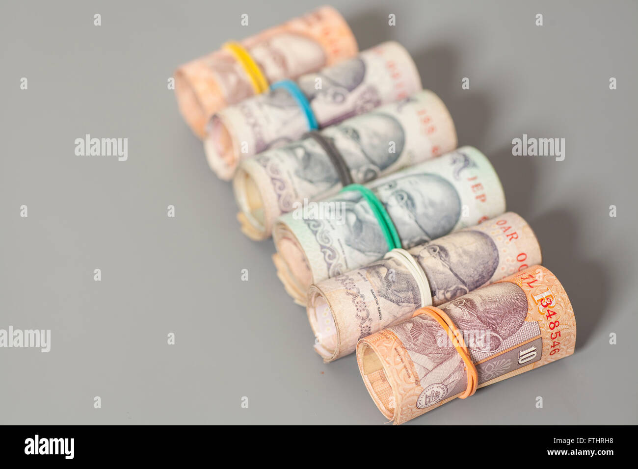 Roll of Indian rupee banknotes isolated on gray Stock Photo - Alamy