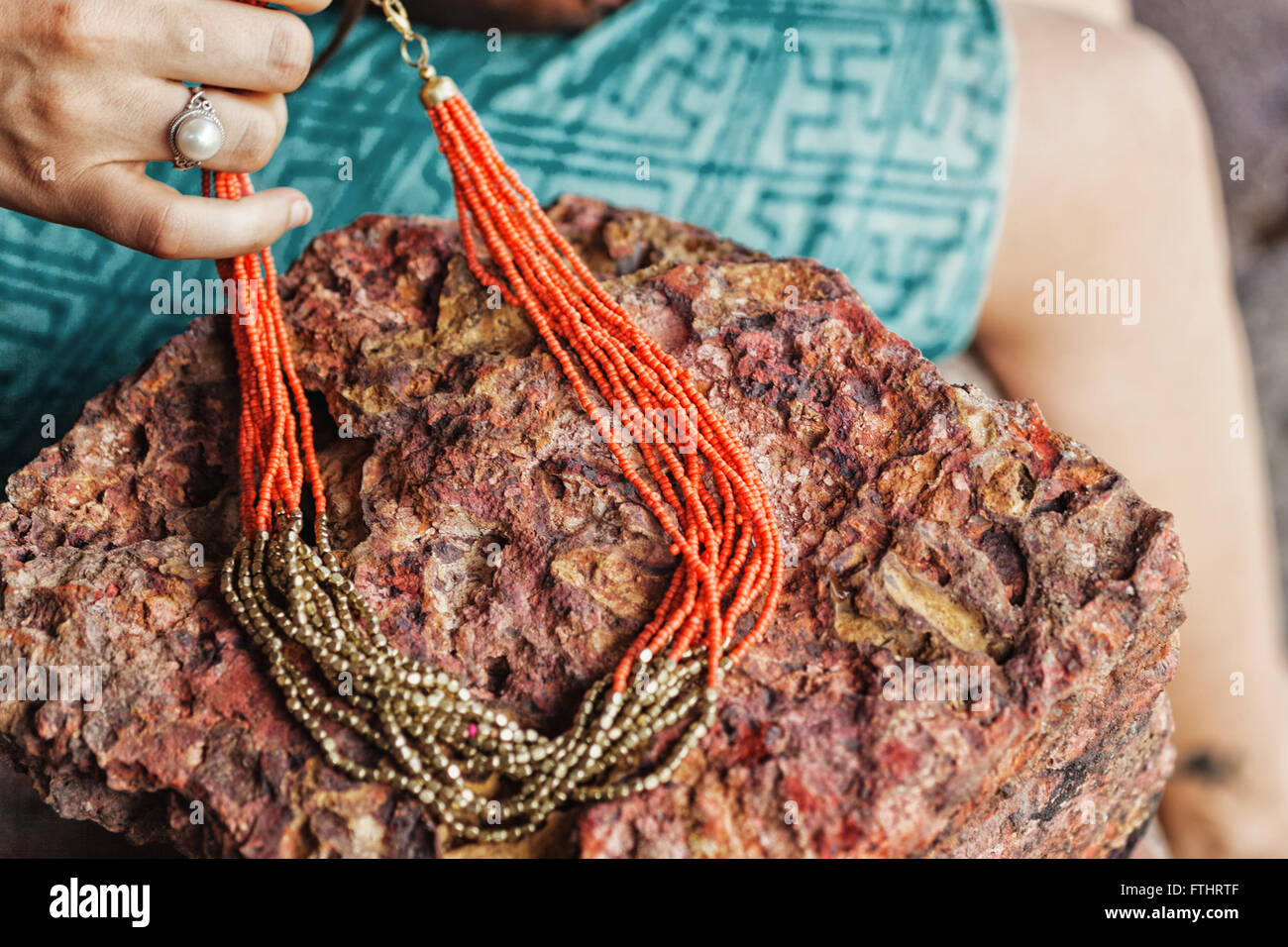 Female hand holding red beads closeup Stock Photo - Alamy