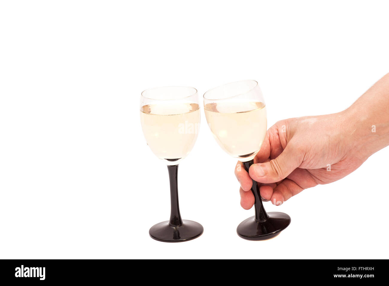 Hand holds glass goblet with champagne isolated on white background ...