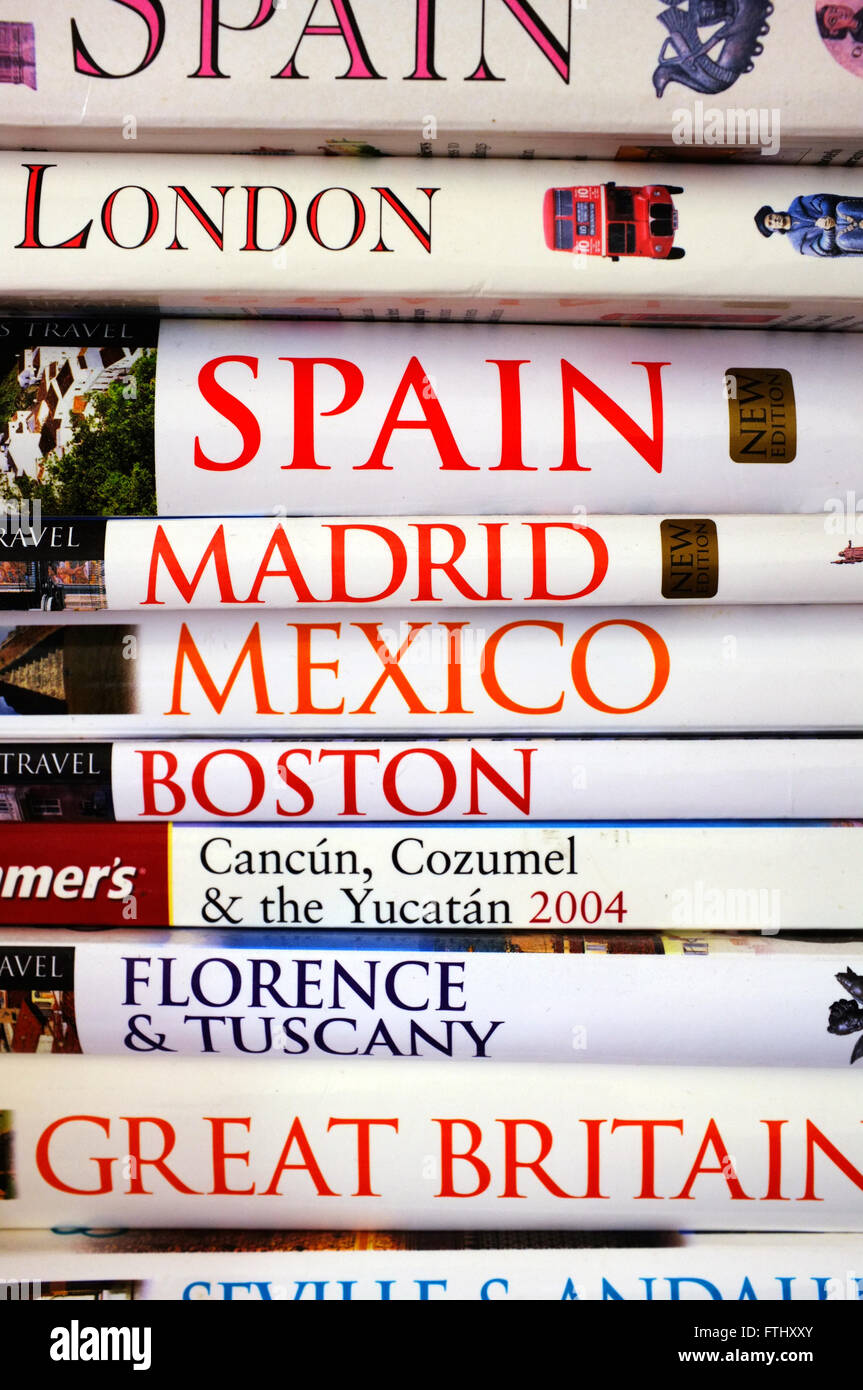 A stack of travel guide books for different countries and cities cross ...