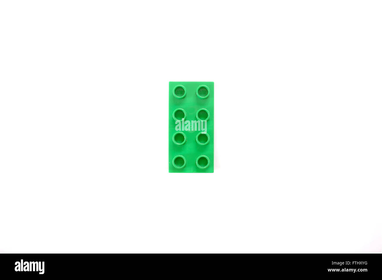 A top view of a green 2X4 Lego brick photographed against a white ...
