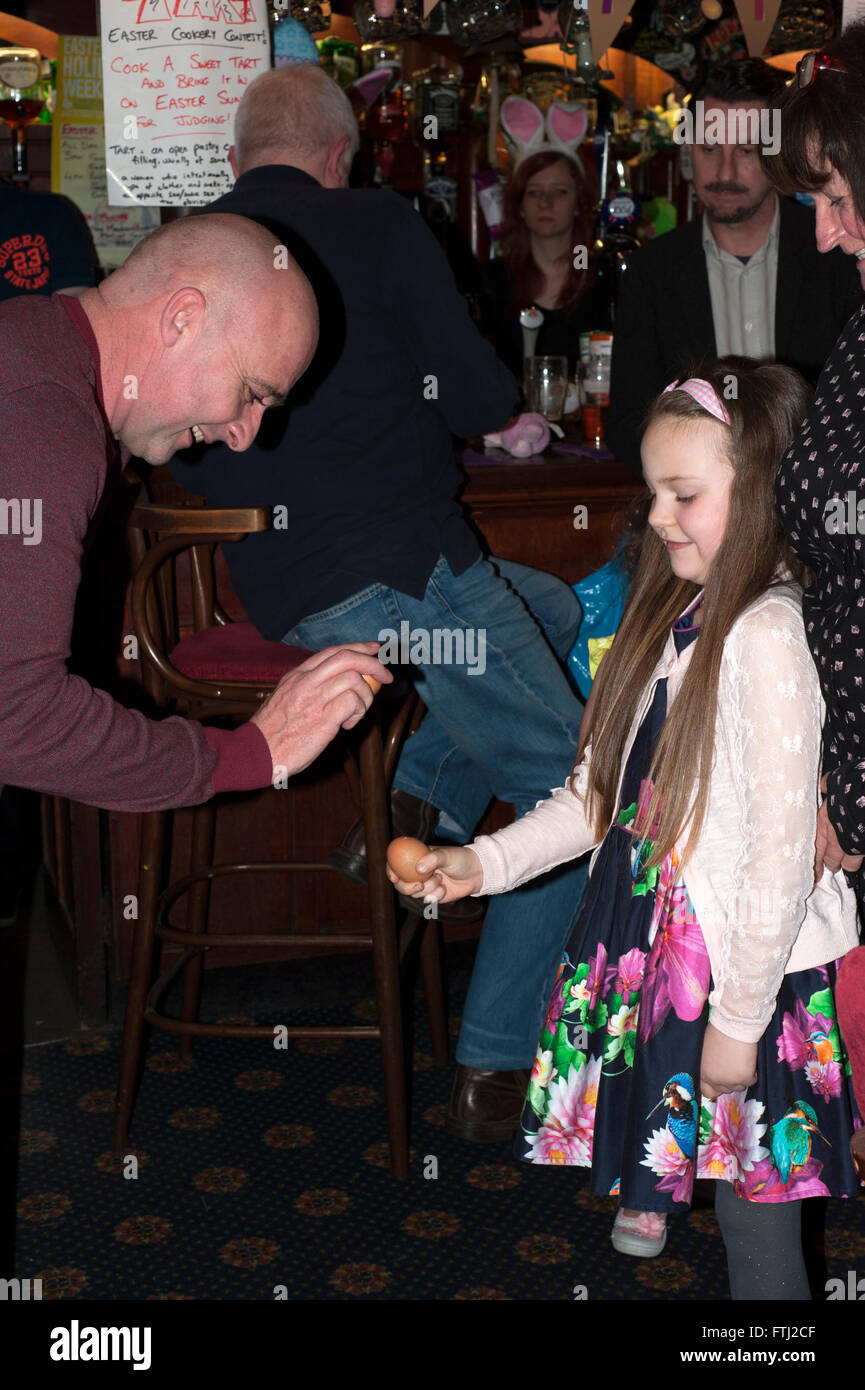 pub customers play traditional easter egg jarping in a contest between ...