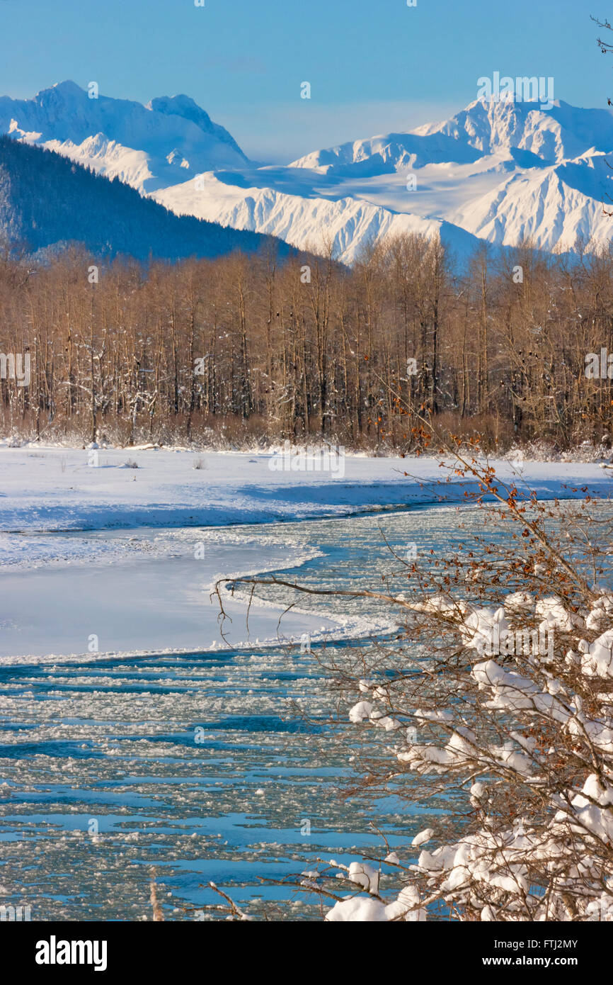 Landscape of river and mountain covered with snow, Haines, Alaska, USA ...