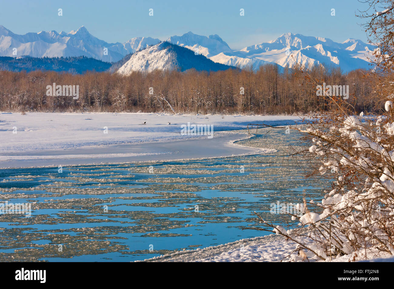 Landscape of river and mountain covered with snow, Haines, Alaska, USA ...