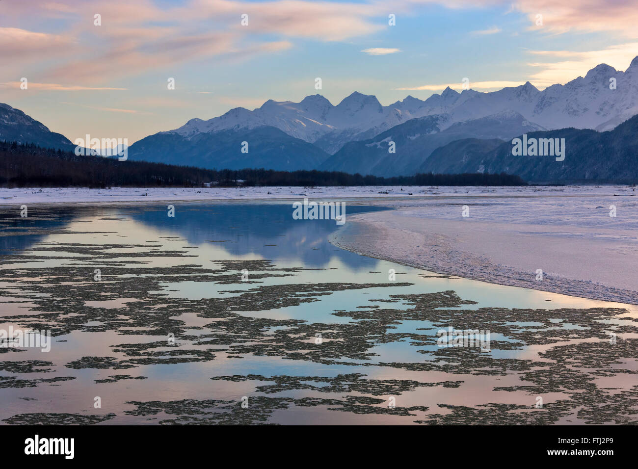 Landscape of river and mountain covered with snow, Haines, Alaska, USA ...