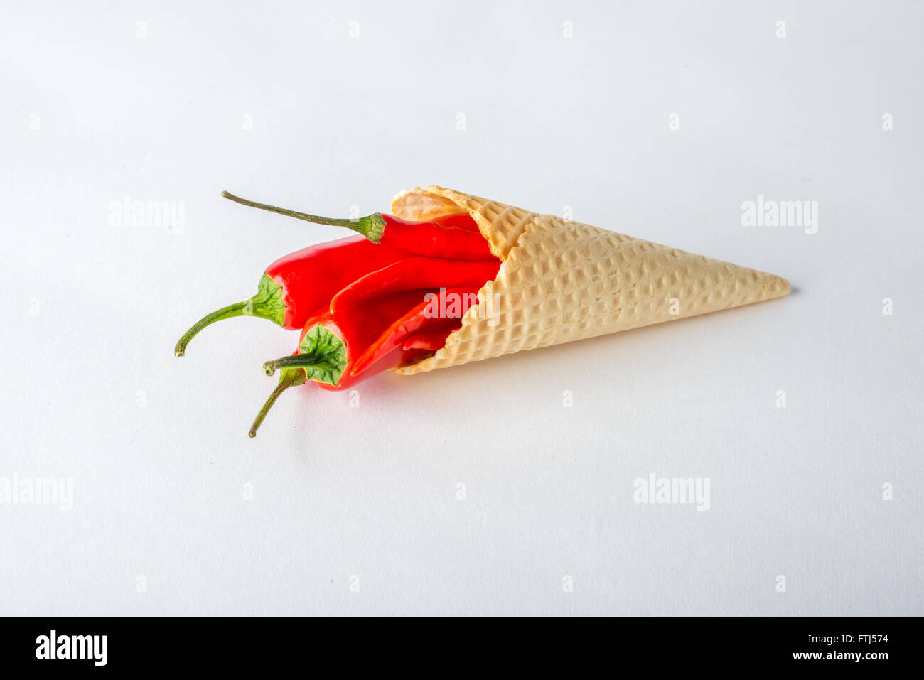 Red hot chili peppers in a wafer cone, unusual food Stock Photo - Alamy