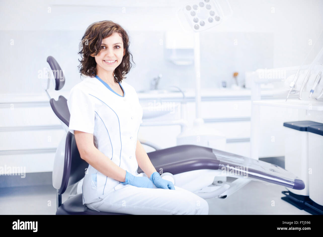 Young professional woman dentist in the office on the background of the ...