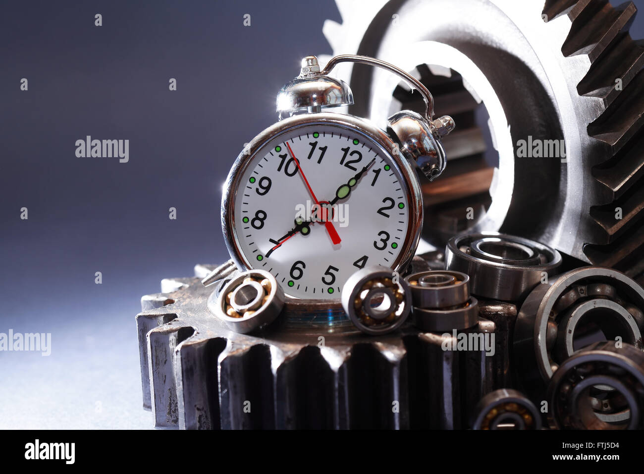 Machinery concept. Alarm clock on heap of old gears and ball bearings ...