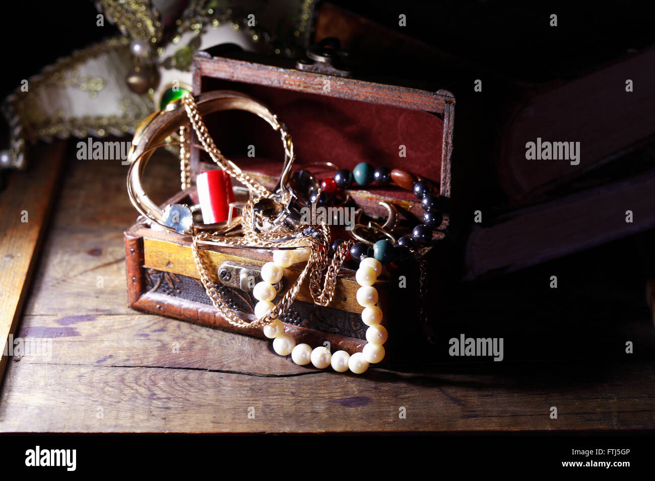 Closeup of open jewelry box on wooden background Stock Photo - Alamy