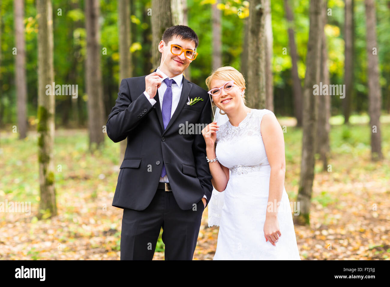 April Fools' Day. Wedding couple posing with stick lips, mask Stock ...