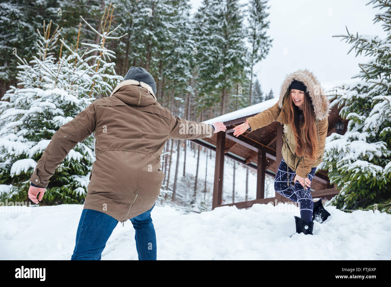 Beautiful couple reaching hands and helping each other while walking in ...