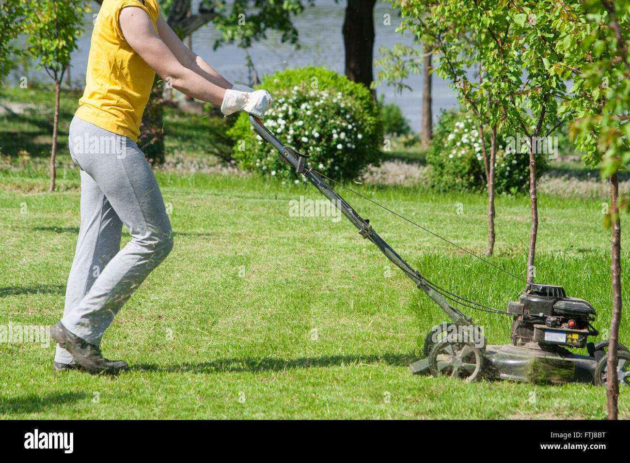 Woman Pushing Lawn Mower High Resolution Stock Photography and Images ...