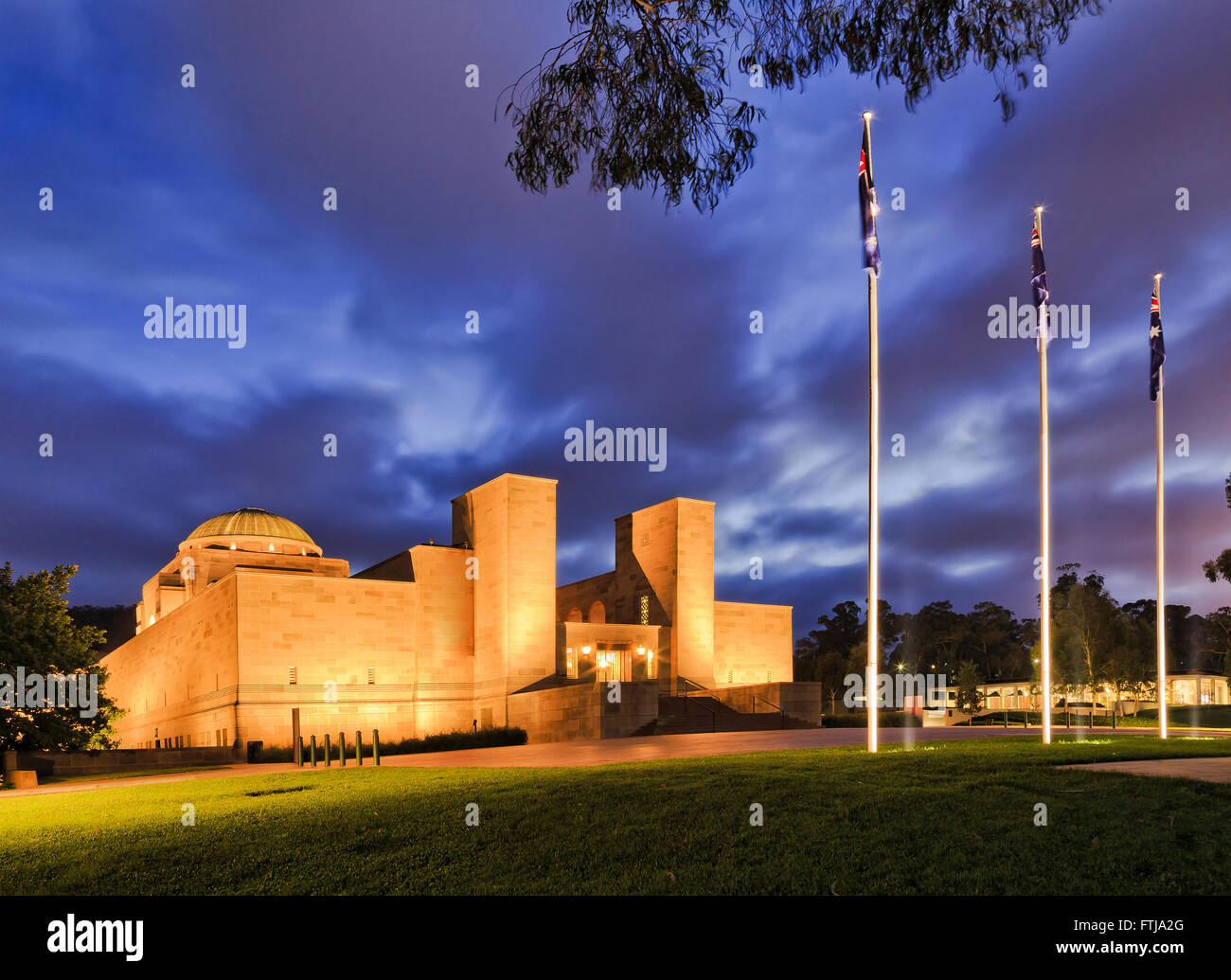 Australian national war memorial in Canberra at sunrise with bright illumination under blurred ...