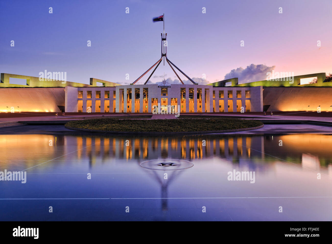 colourful reflection of Canberra's new parliament building in a fontain ...