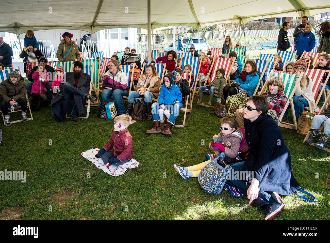 Families watch a performance in a marquee Stock Photo - Alamy