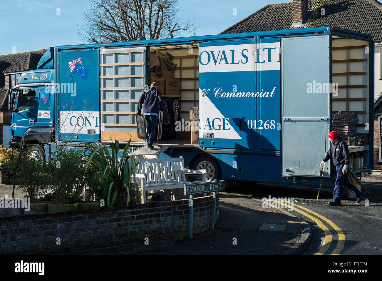 A removal man loads household items into a removal van Stock Photo - Alamy