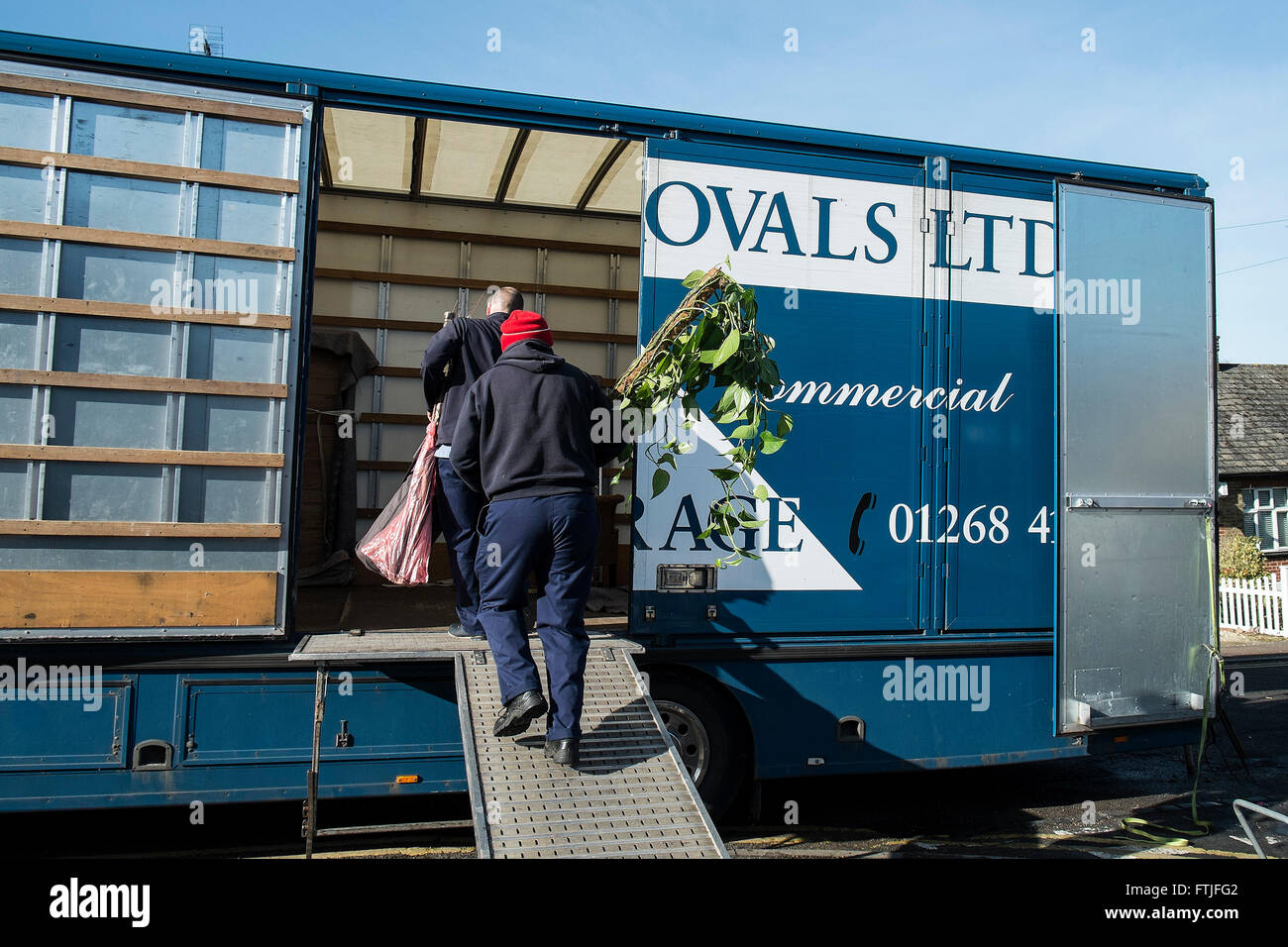 Removal men load household items into a removal van Stock Photo - Alamy
