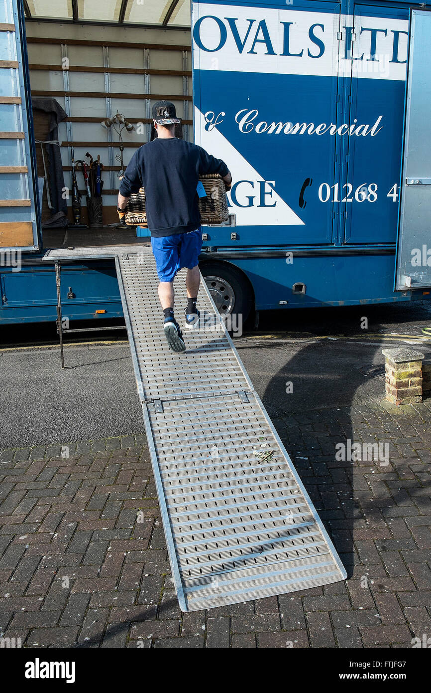 A removal man loads household items into a removal van Stock Photo - Alamy