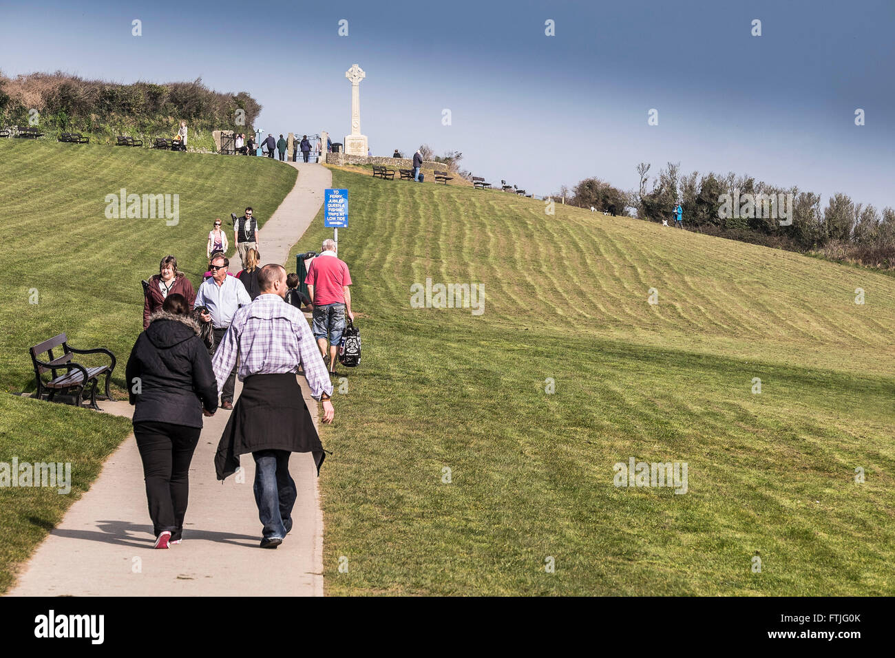People enjoy an afternoon stroll along the path leading up to the War ...