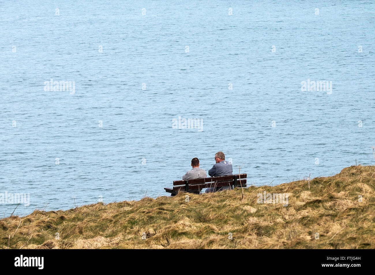 Two men sitting on bench hi-res stock photography and images - Alamy
