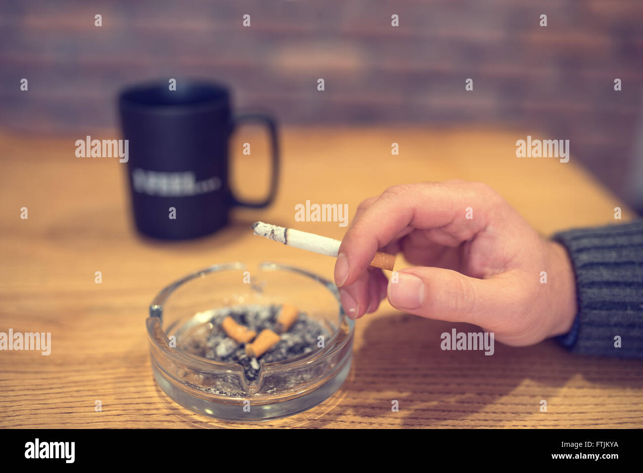 smoking cigarette on table Stock Photo - Alamy