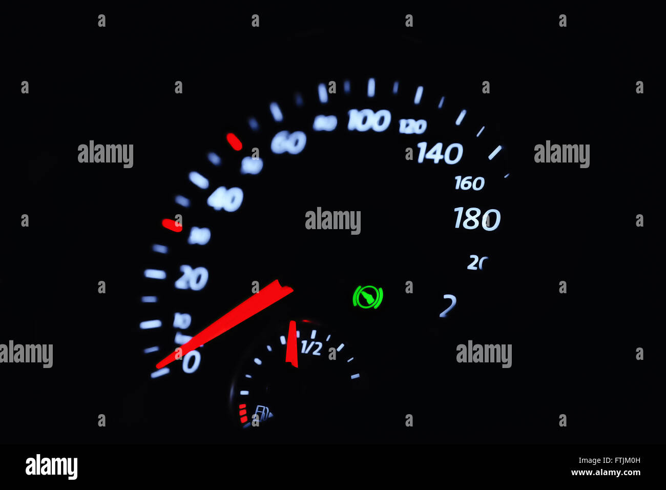 Bright dial speedometer in the dark closeup Stock Photo - Alamy