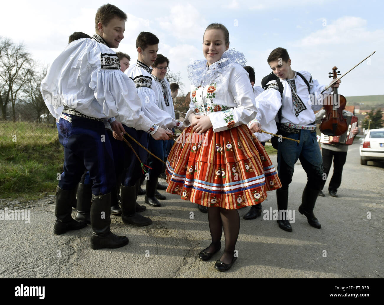 Vlcnov, Czech Republic. 28th Mar, 2016. Young men in folk costume whip ...